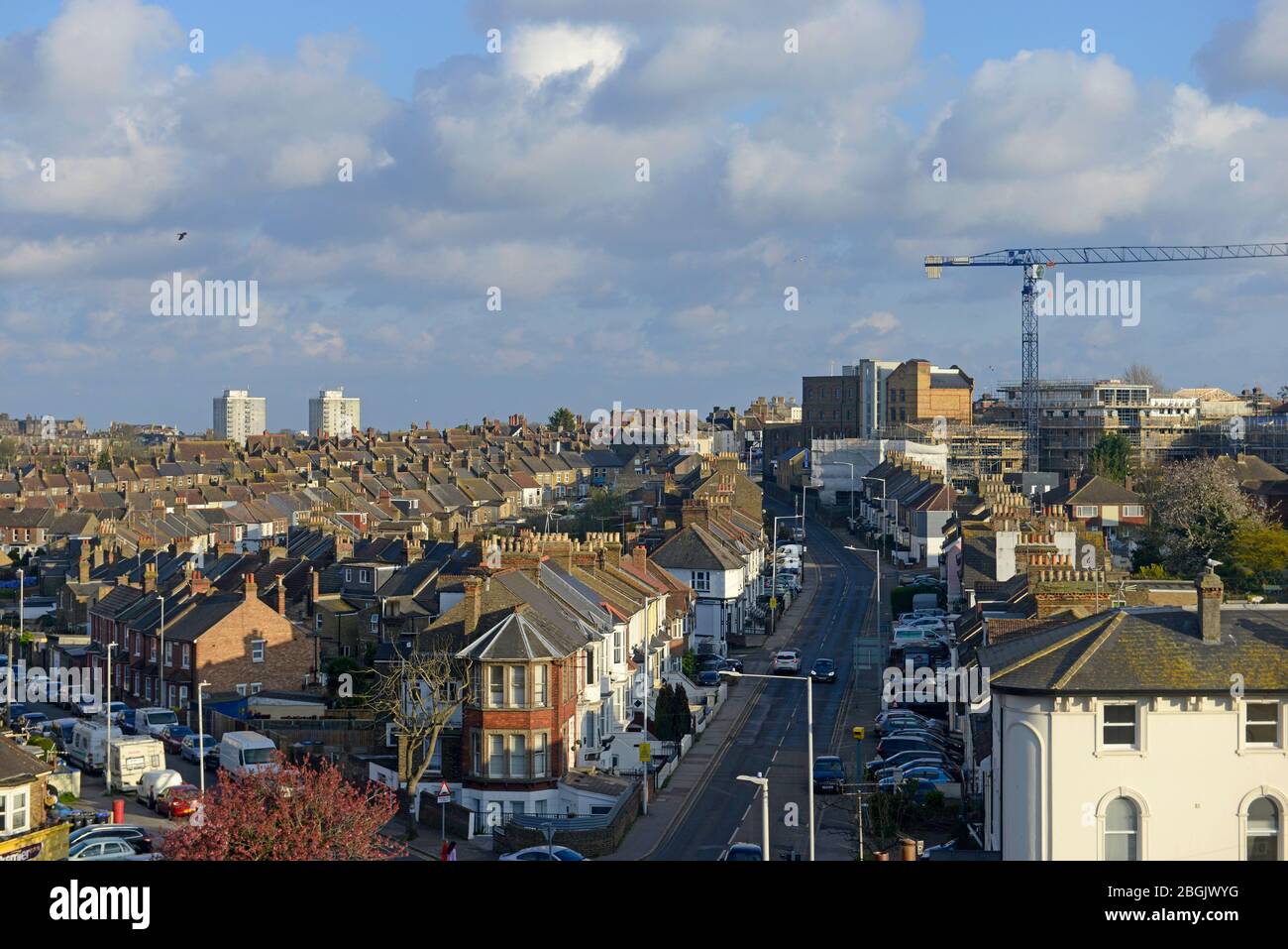 View over a street and rooftops in Folkestone, Kent, UK from a passing ...