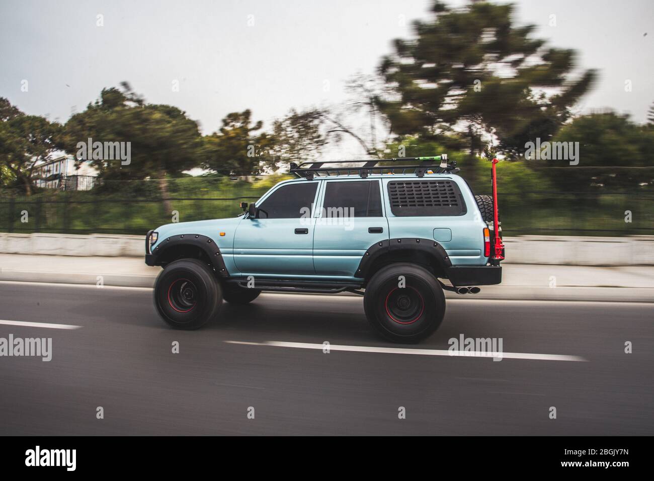 Blue offroader truck on the countryside road Stock Photo - Alamy