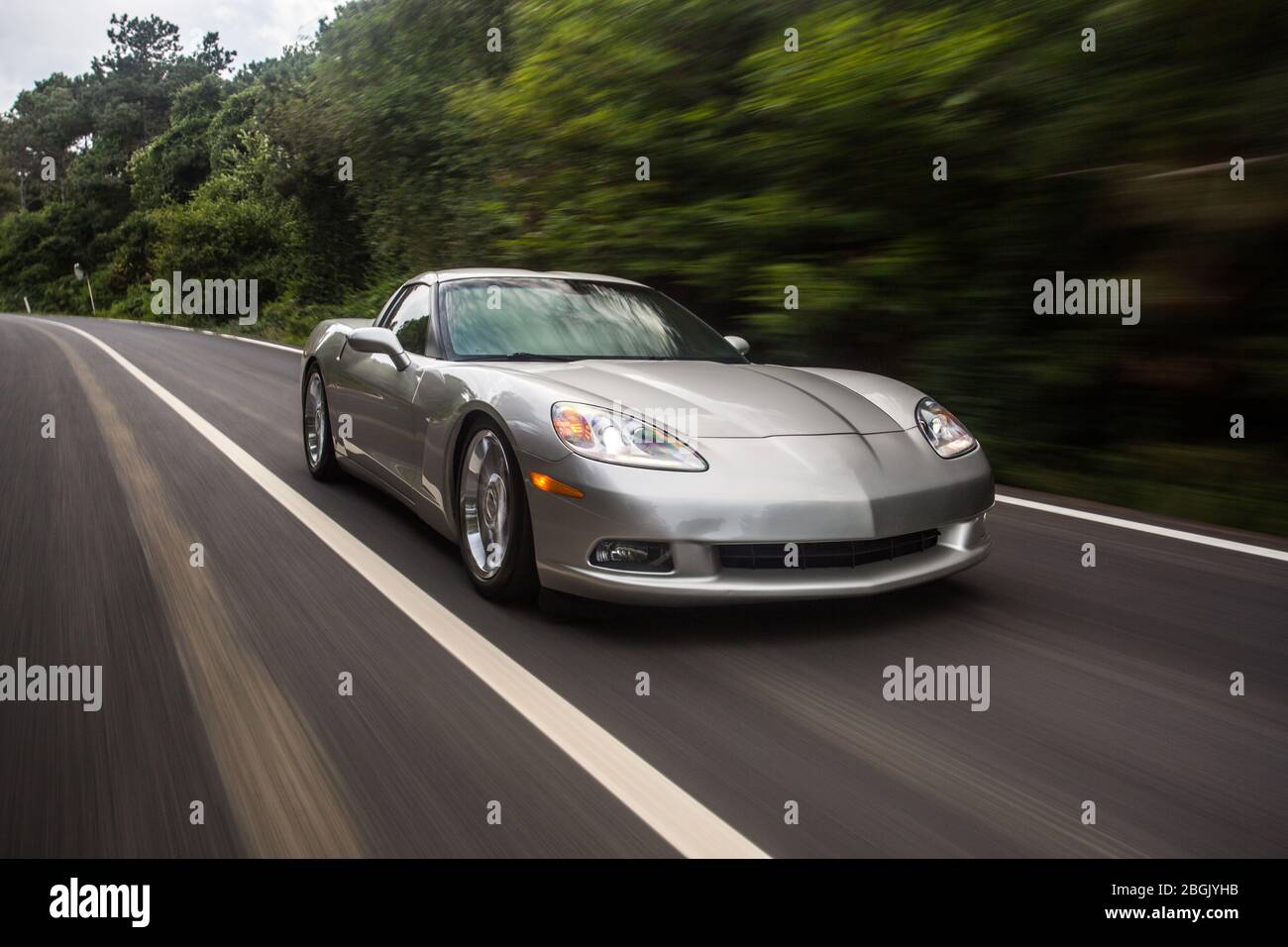 Black modern cabriolet in the rain forests, no limit drive Stock Photo ...