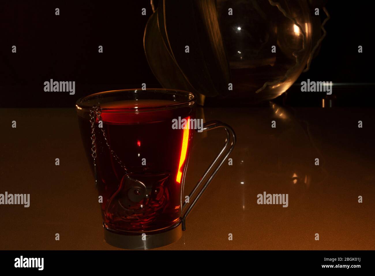 Cup with hot water painted in red sweat while the individual silver ...