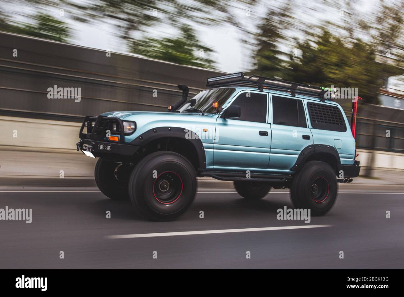 Blue offroader truck on the countryside highway Stock Photo - Alamy