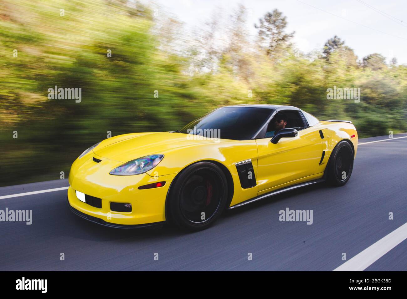 Yellow super racing car in the forest Stock Photo - Alamy