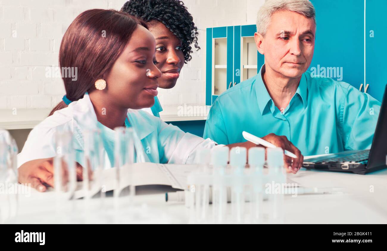 Progress report in test laboratory. Female African medical students ...