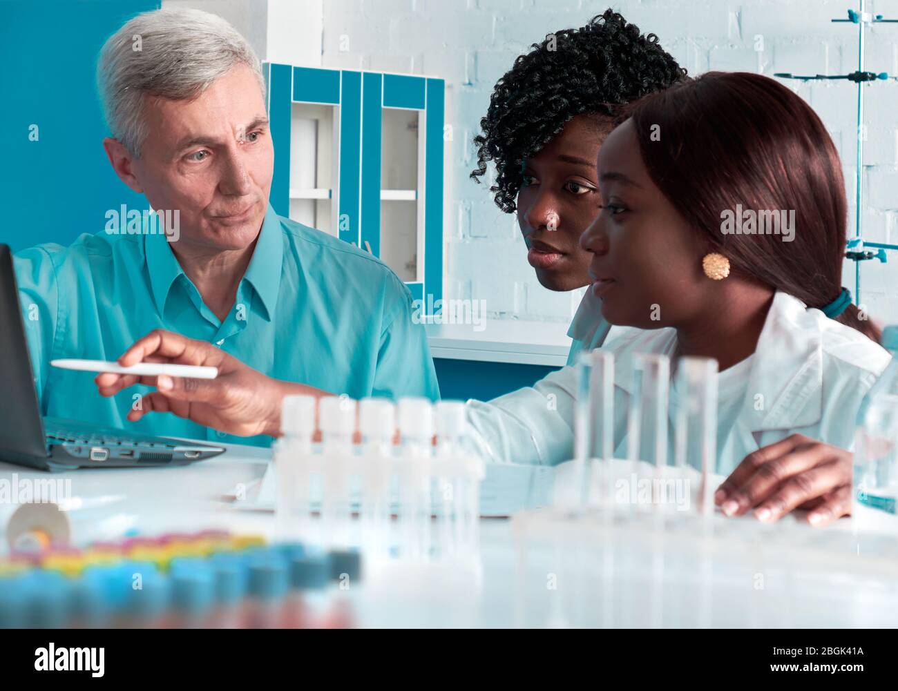 Progress report in test laboratory. Female African medical students ...