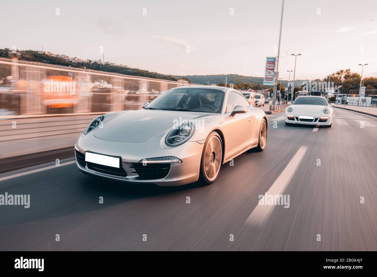 Silver sport car rush drive in the bay town, front view Stock Photo - Alamy