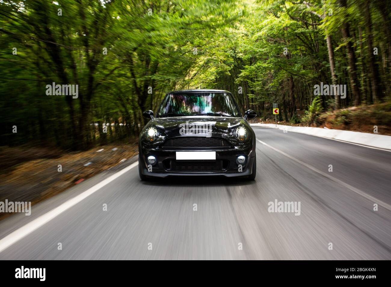 Blue mini supercar autoshow through landscapes in the rain forest Stock ...