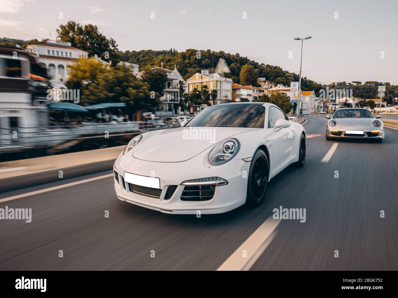 White sport car rush drive in the bay town, front view Stock Photo - Alamy