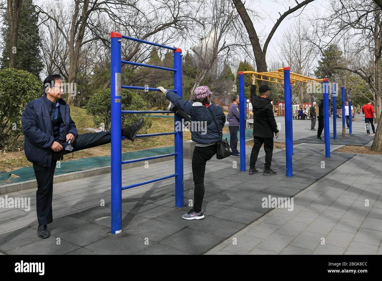 Citizens do exercise by jogging or with fitness equipment at a local ...