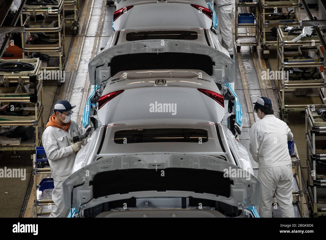 Staff of a local factory owned by Honda Motor Company, a Japanese ...