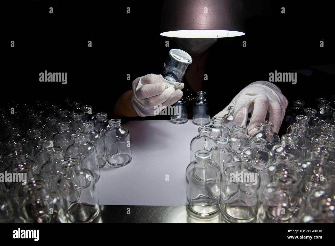 Staff of Guangming glass factory work along the automated production ...