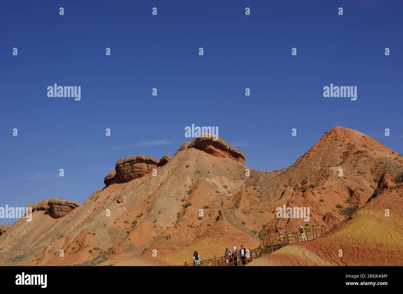 An aerial of mountains of Danxia Landform with colorful strips at Qicai ...
