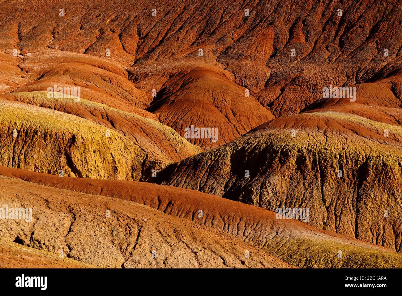 An aerial of mountains of Danxia Landform with colorful strips at Qicai ...