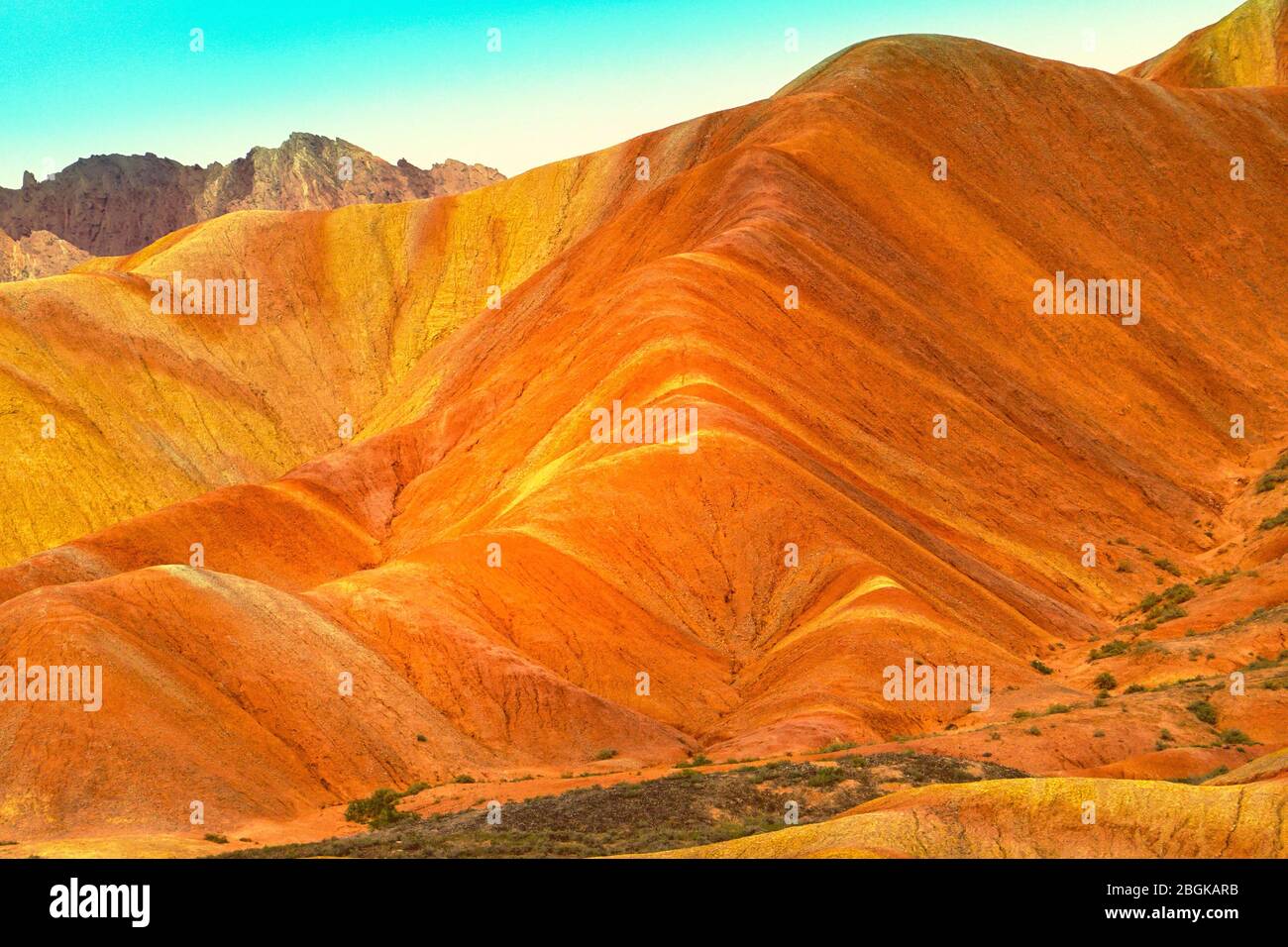 An aerial of mountains of Danxia Landform with colorful strips at Qicai ...