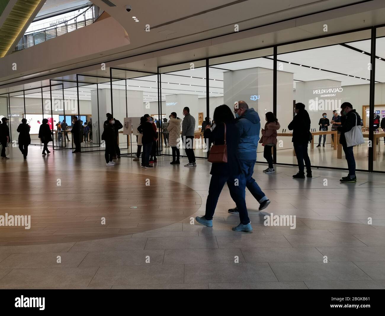 People line up outside a shopping mall to get inside in Qibao district ...