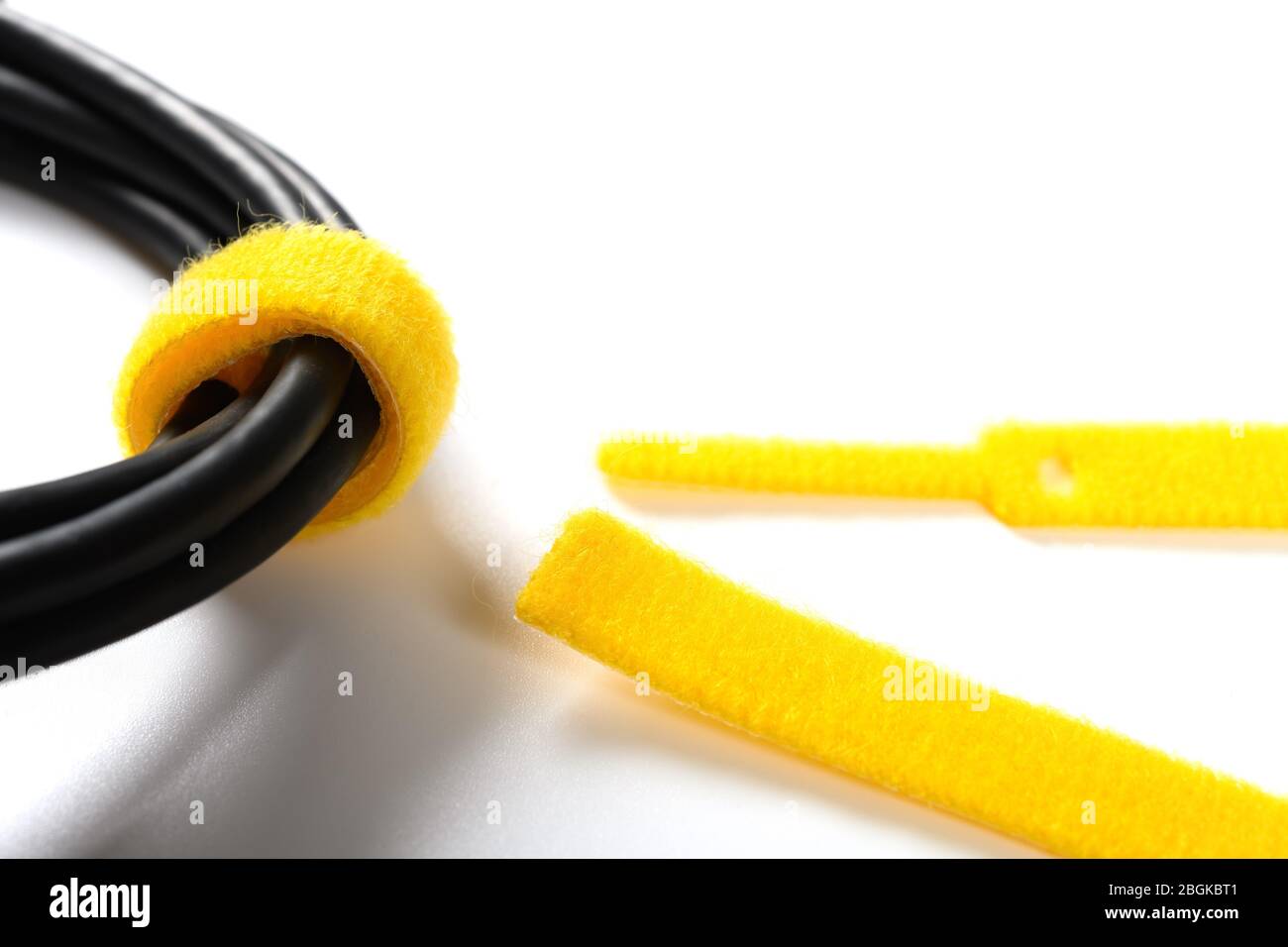 yellow velcro cable tie and cable on white Stock Photo - Alamy