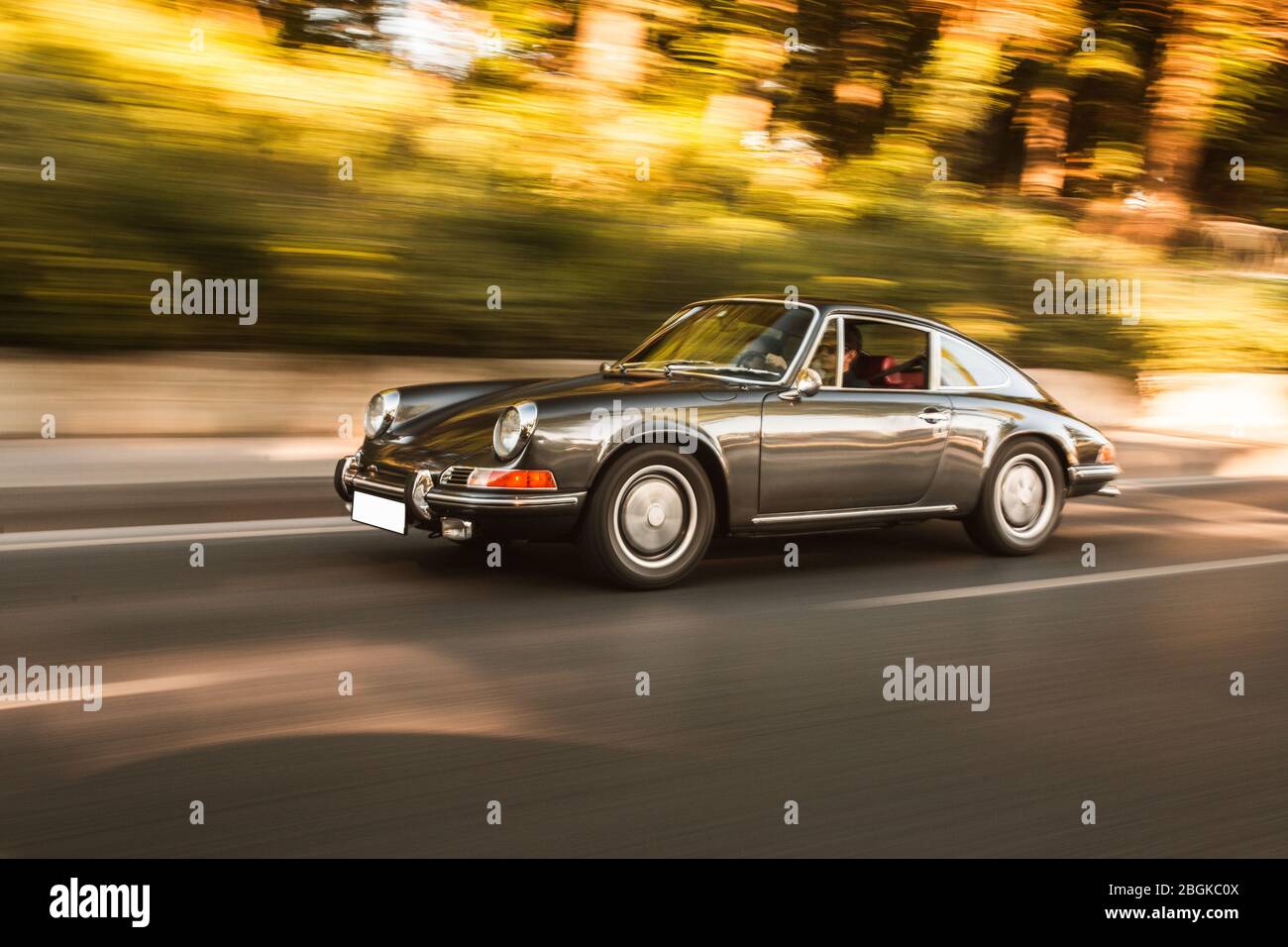 A classic old fashioned sedan on the forest road Stock Photo - Alamy