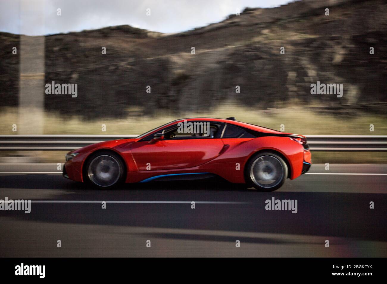 Red modern design car on the highlands, profile view Stock Photo - Alamy