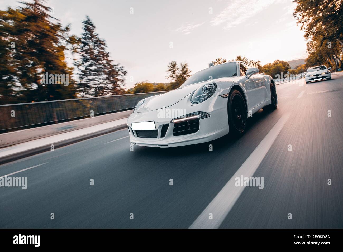 White sport car rush drive in the downtown Stock Photo - Alamy