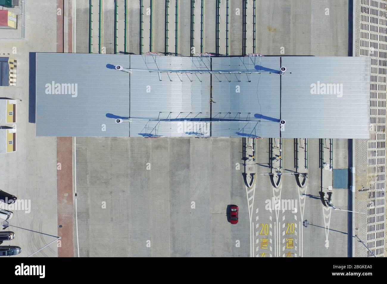 An aerial view of a car driving through the checkpoint of Qingdao ...