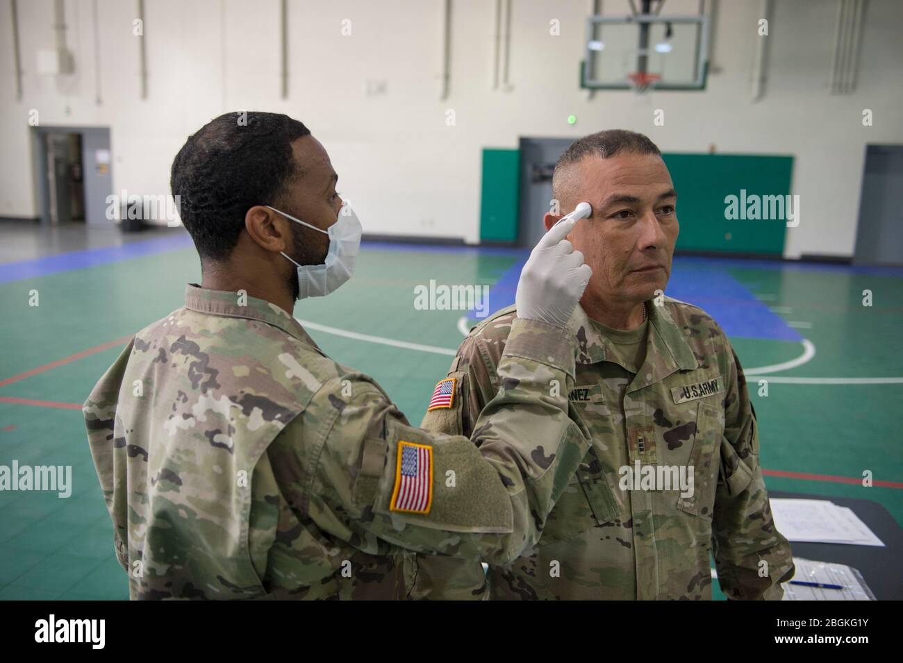 Sgt. 1st Class Jerry Rushing tests the temperature of a Soldier before ...