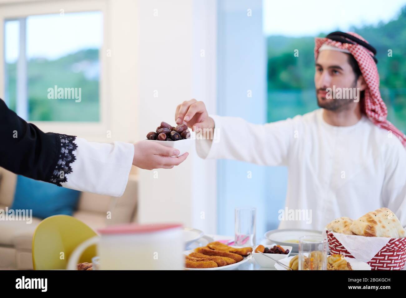 Eid Mubarak Muslim family having Iftar dinner eating dates to break ...