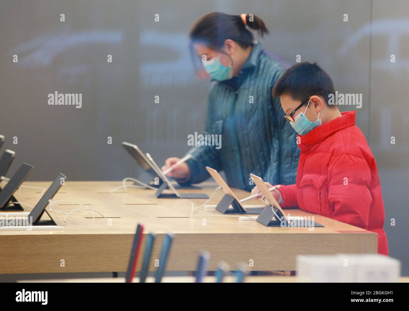 Customers try out products at a reopened flagship store of American ...