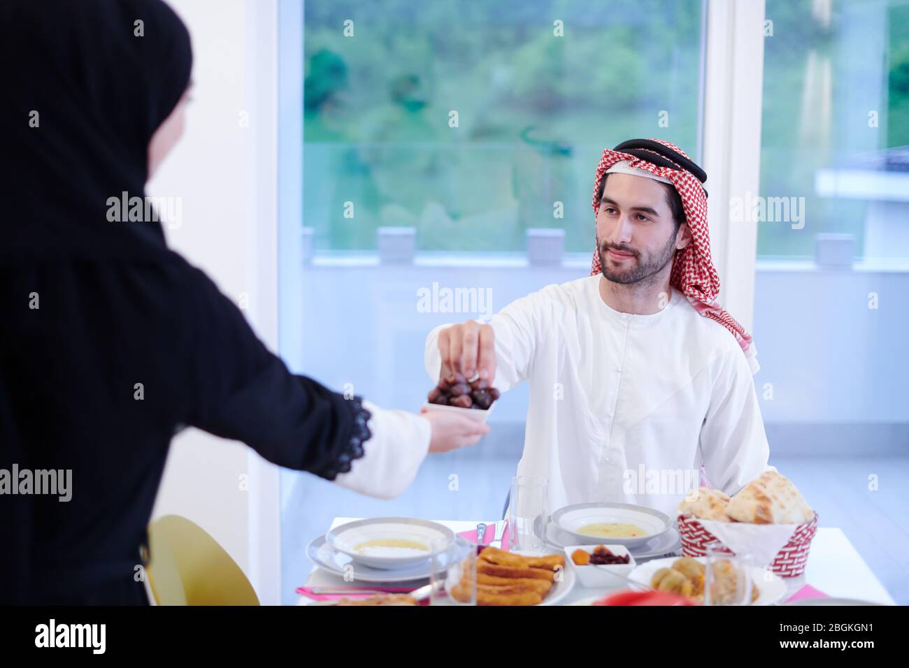 Eid Mubarak Muslim family having Iftar dinner eating dates to break ...