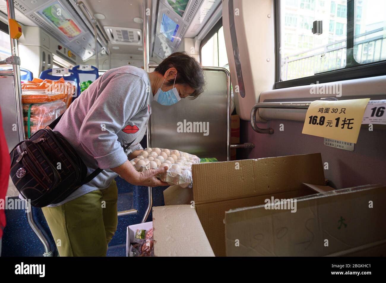 Residents purchase at the bus supermarket, which is a cooperation of ...