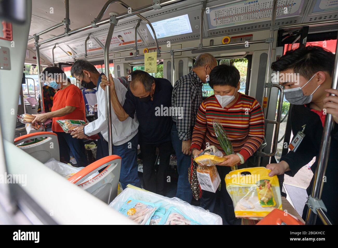 Residents purchase at the bus supermarket, which is a cooperation of ...