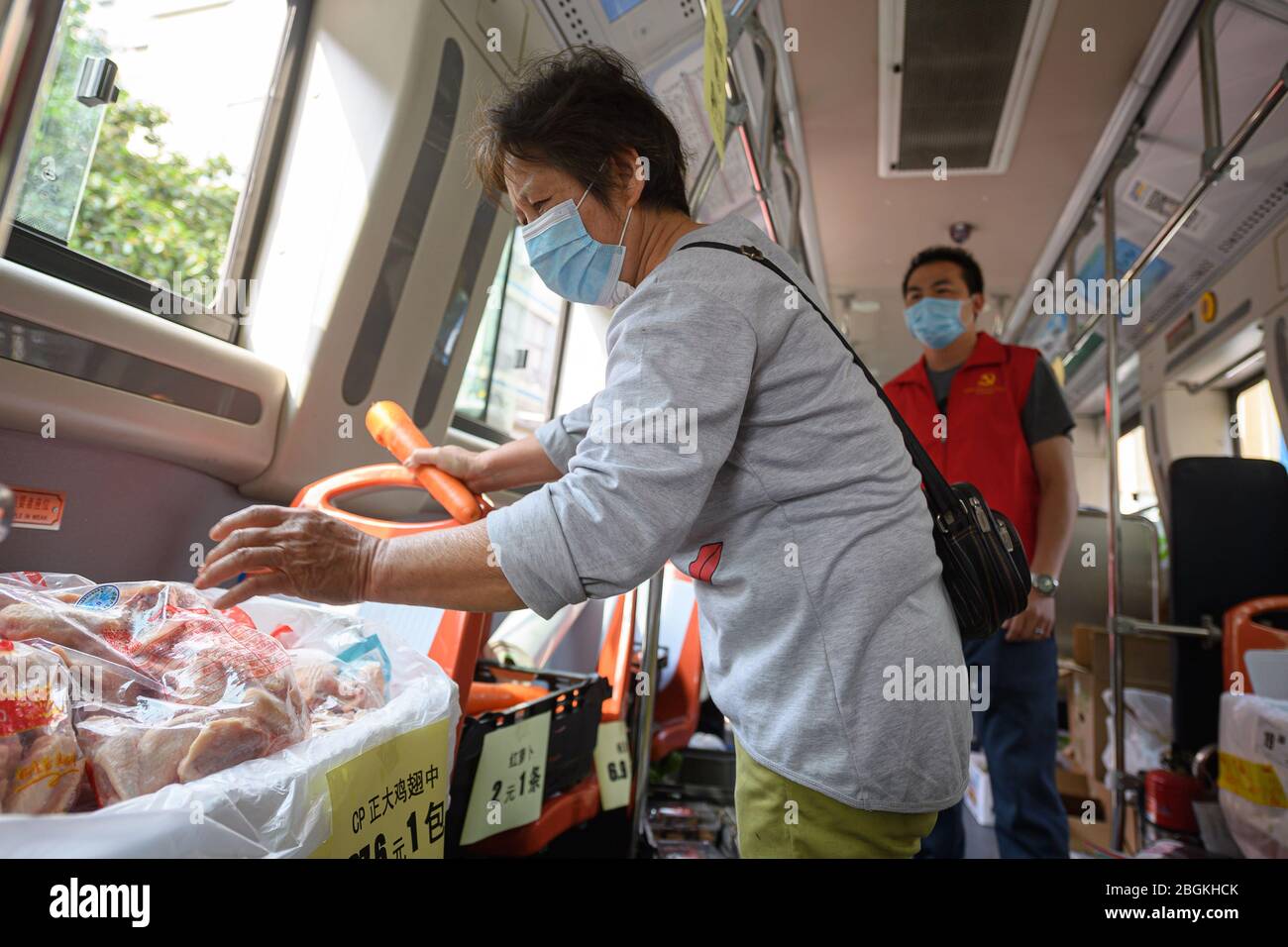 Residents purchase at the bus supermarket, which is a cooperation of ...