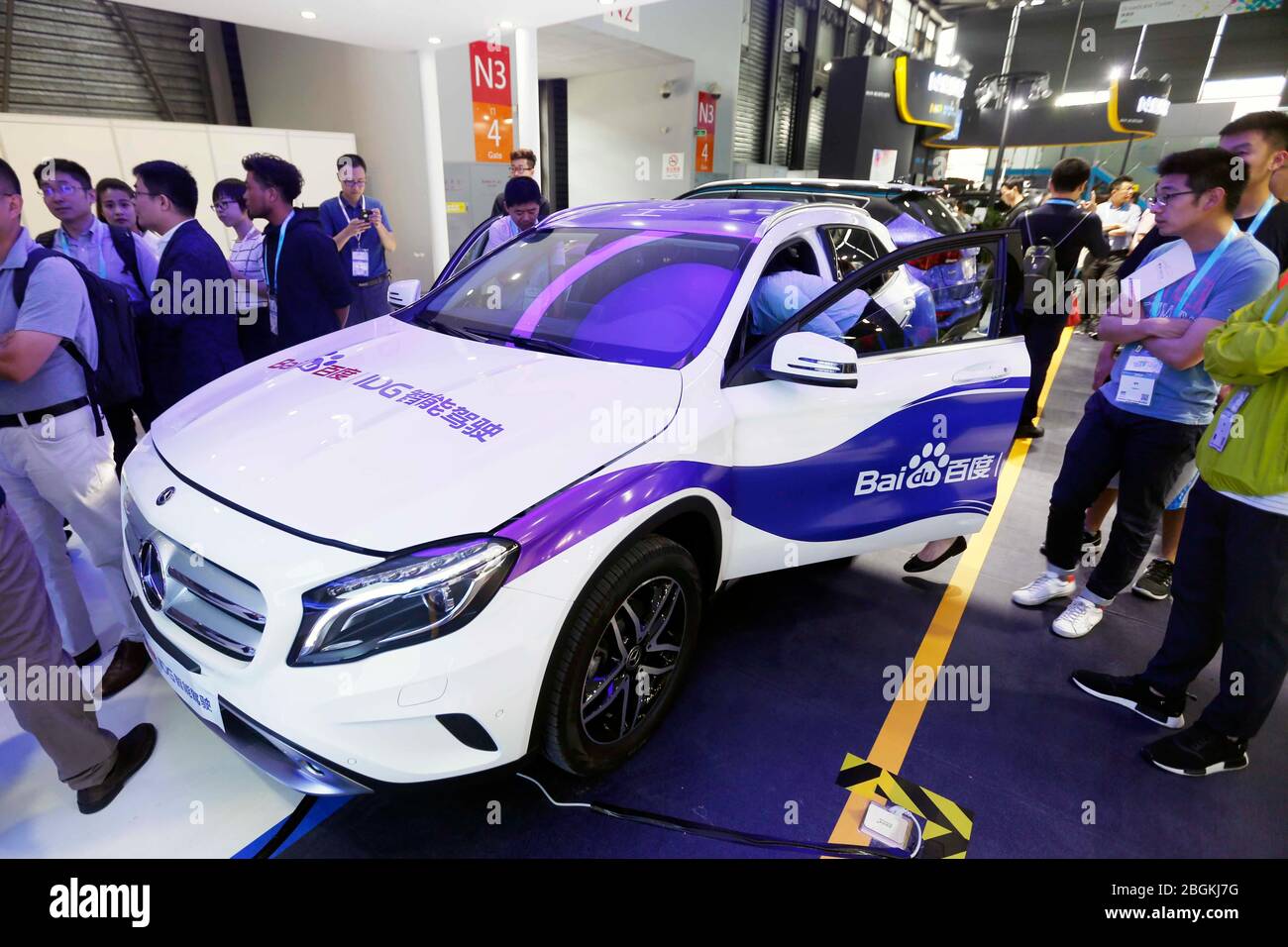 Visitors gather around a model of the vehicle containing Apollo, an ...