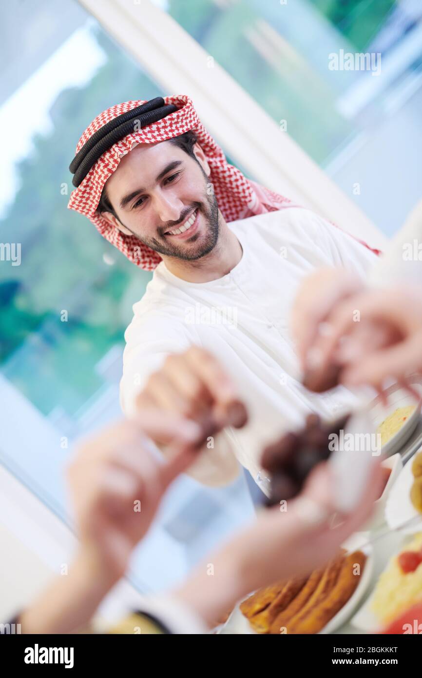 Eid Mubarak Muslim family having Iftar dinner eating dates to break ...