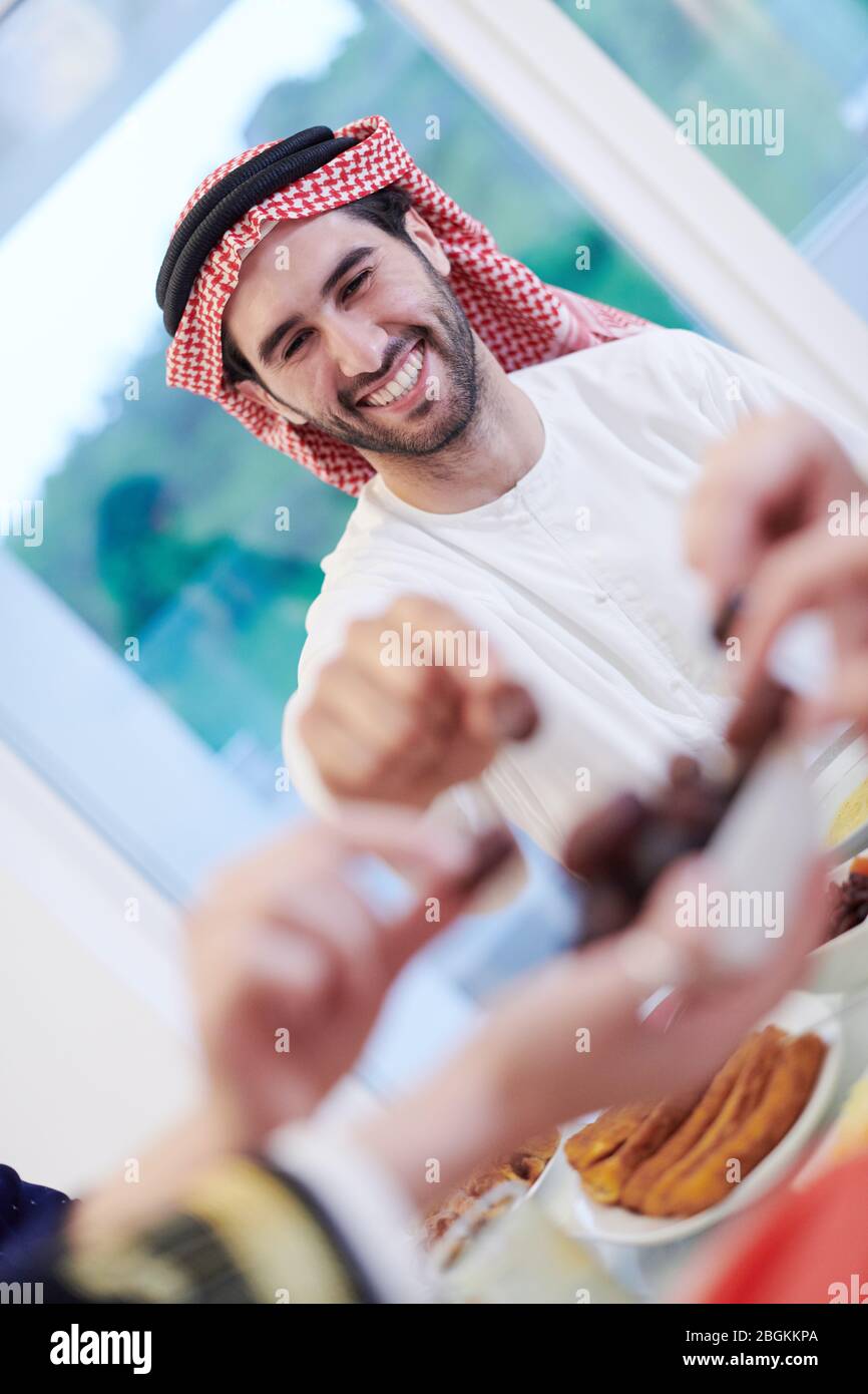 Eid Mubarak Muslim family having Iftar dinner eating dates to break ...