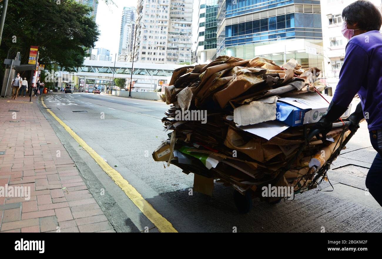 An old woman pushing a cart full of used cardboard Stock Photo - Alamy