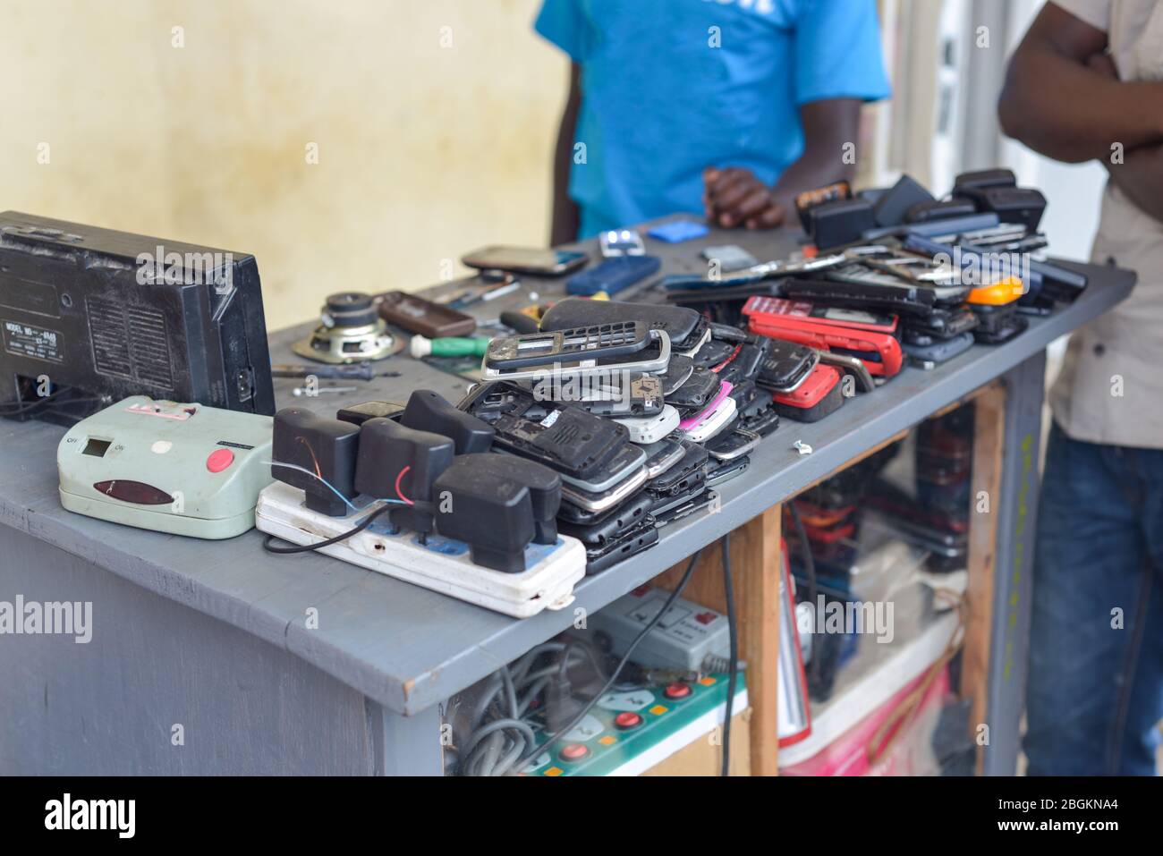 old mobile phones on top of a desk in repair shop in the streets of ...