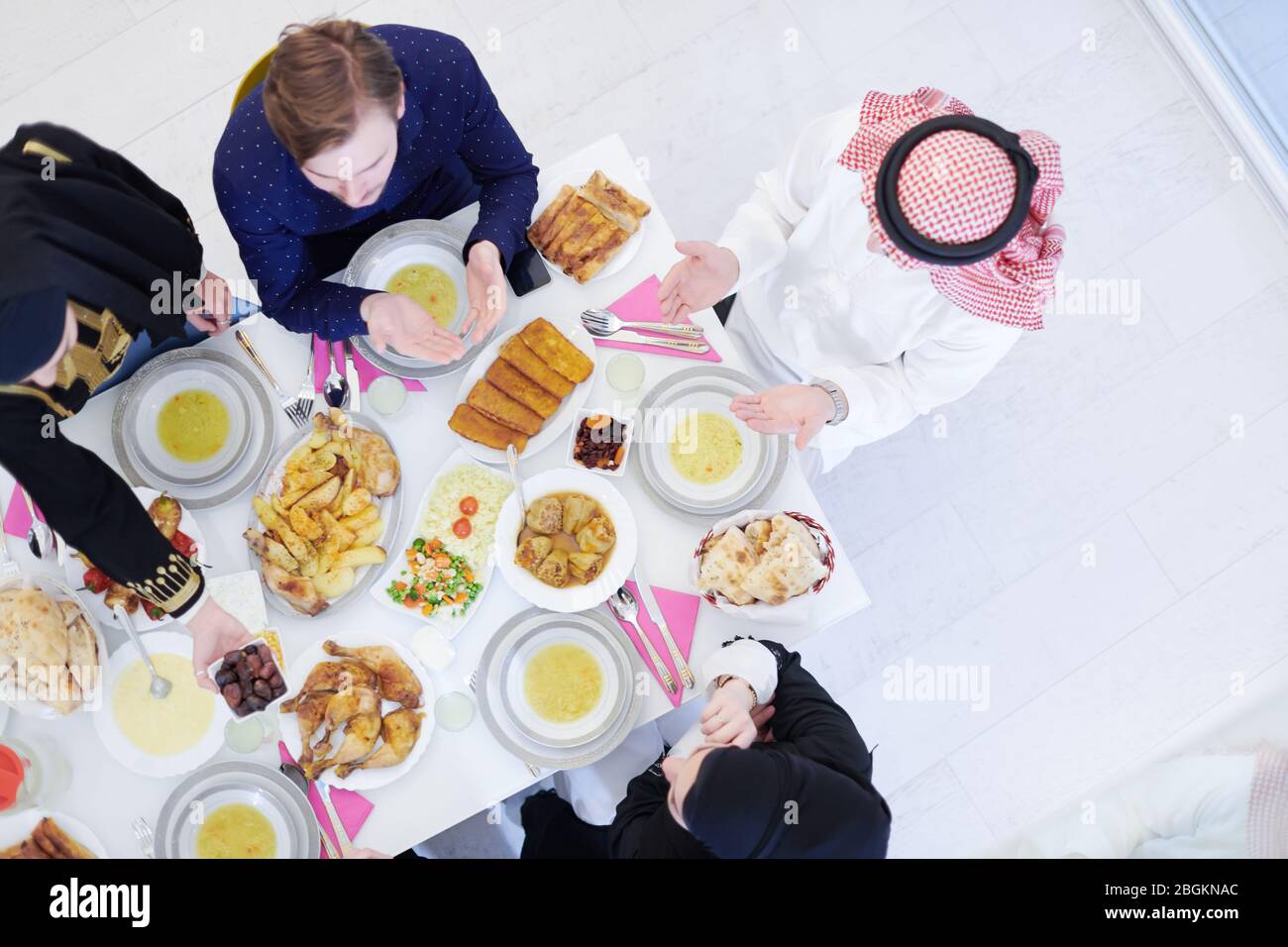 Eid Mubarak Muslim people praying before iftar dinner. Eating ...