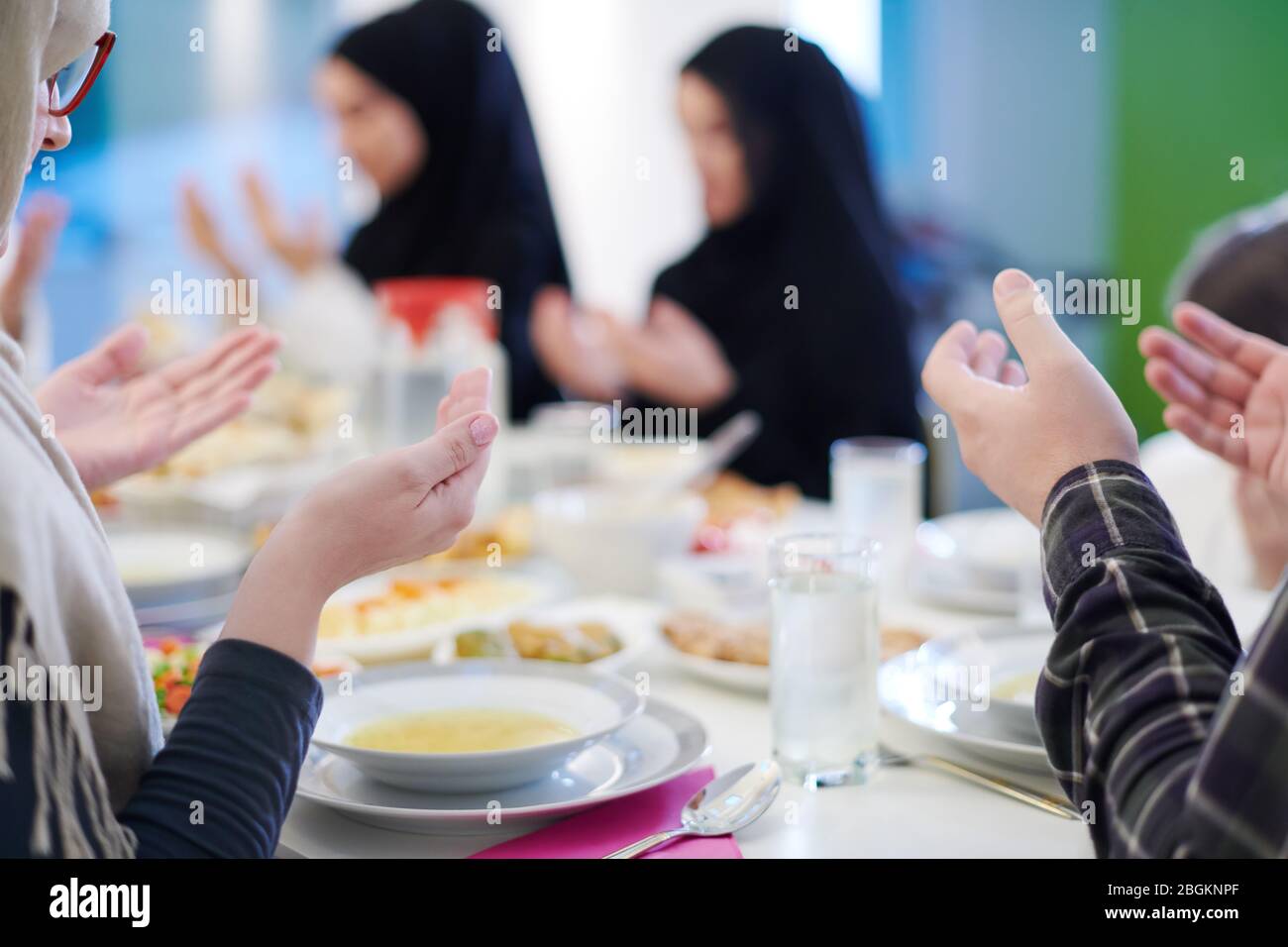Eid Mubarak Muslim people praying before iftar dinner. Eating ...