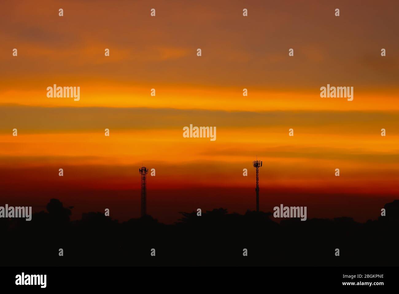 Silhouette of Beautiful sunset with television antenna or telecommunications towers have a lot ...
