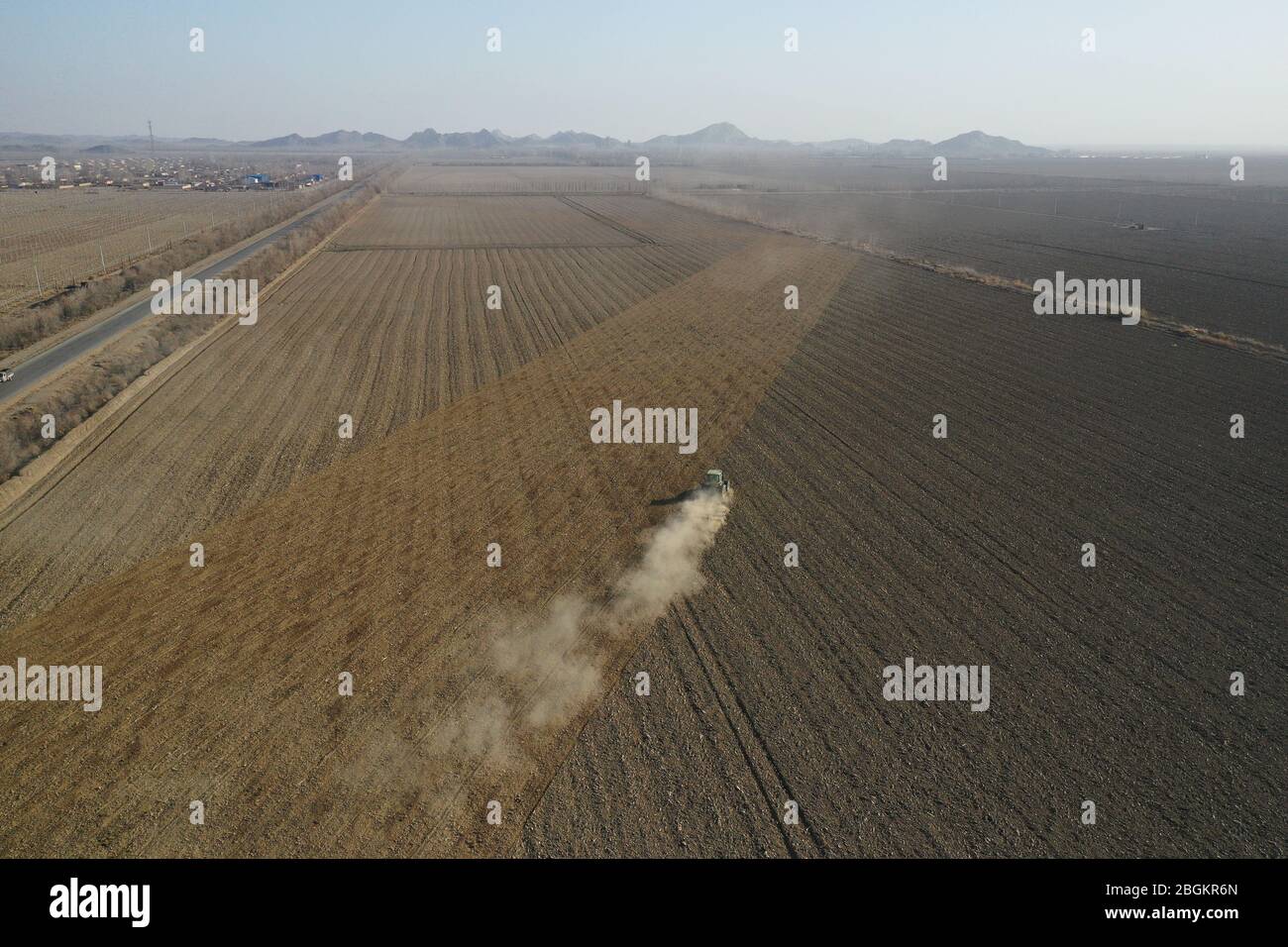 An aerial view of an agricultural machine running in the field, a ...