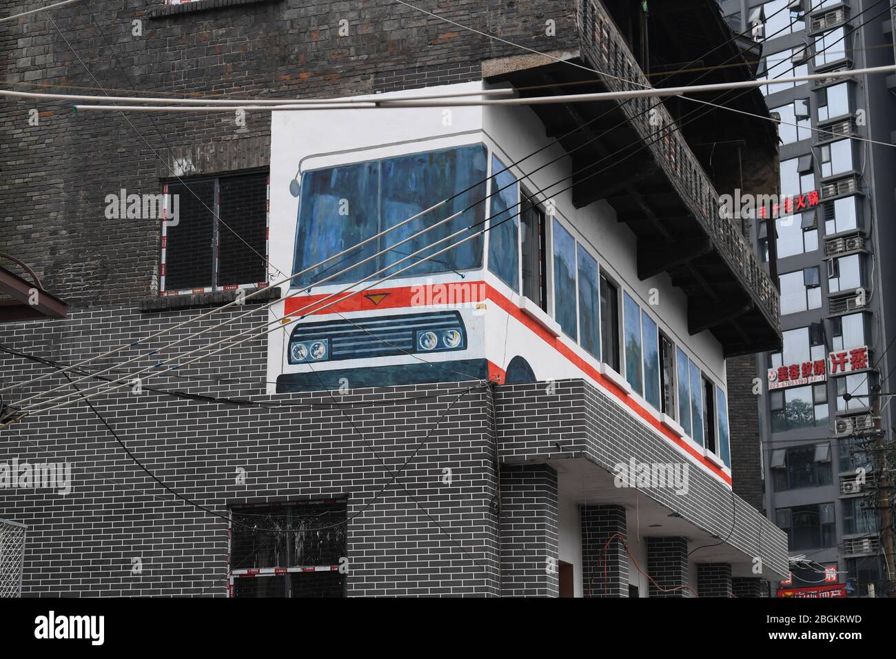 A mural of bus drawn on the wall of the second floor of a local ...