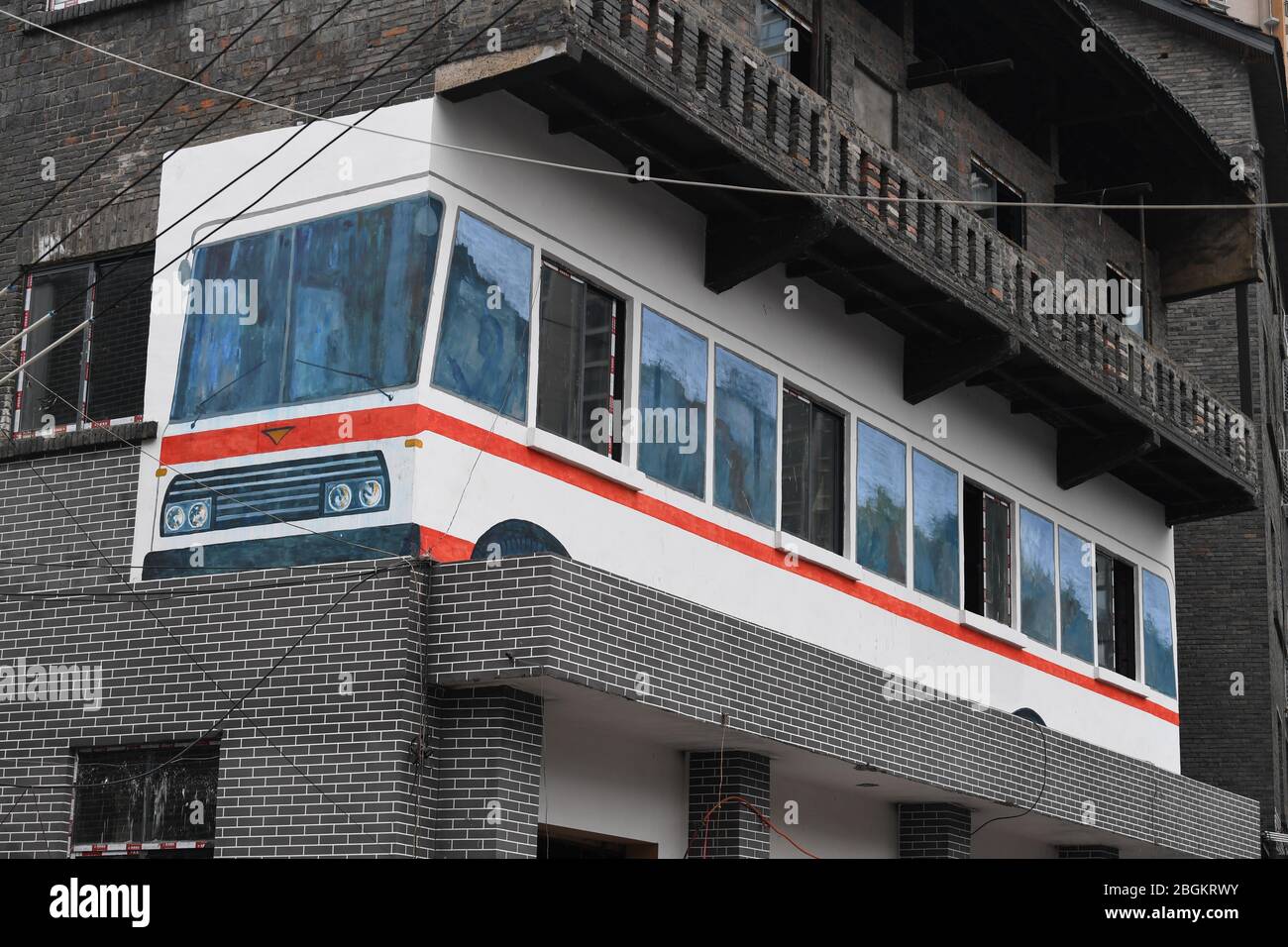 A mural of bus drawn on the wall of the second floor of a local ...