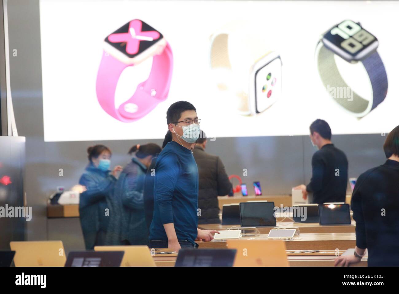 Customers try out products at a reopened flagship store of American ...