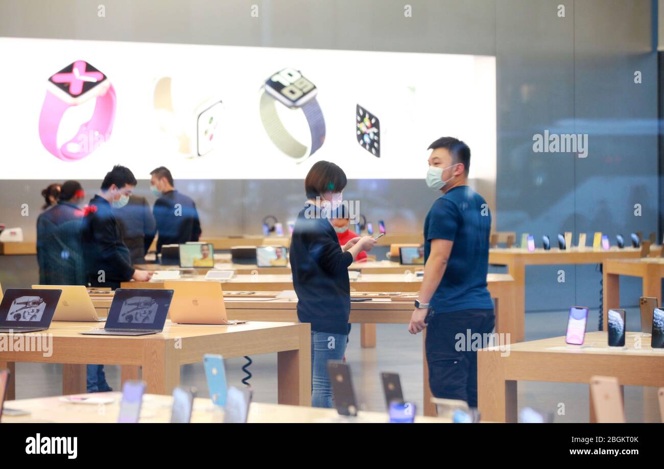 Customers try out products at a reopened flagship store of American ...