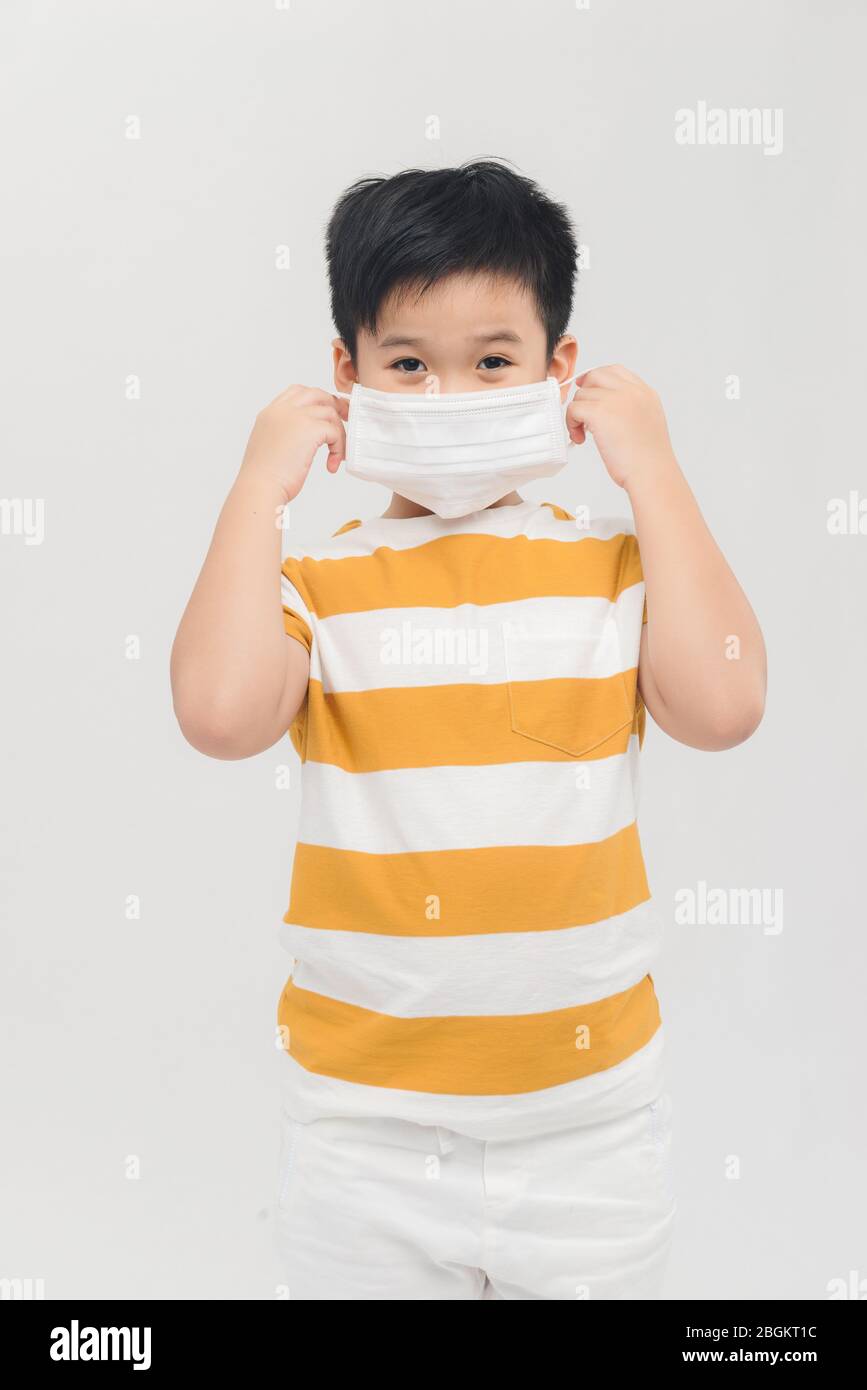 A little boy is holding a medical mask. Baby wears face masks covid-19 ...
