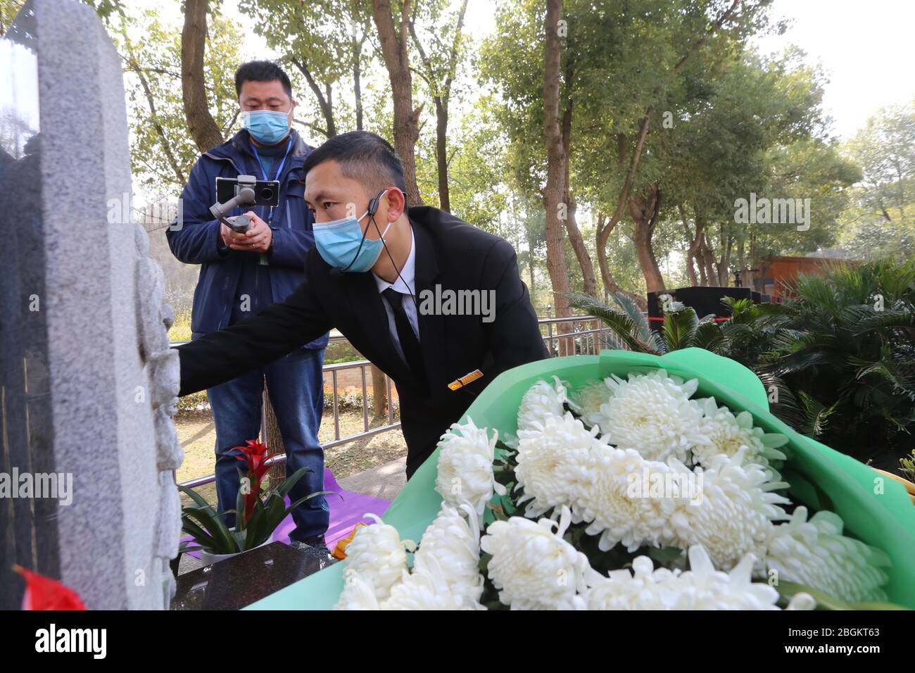 A staff of a local cemetery does online tomb sweeping and worshiping to ...