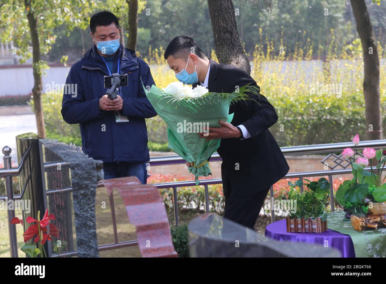 A staff of a local cemetery does online tomb sweeping and worshiping to ...