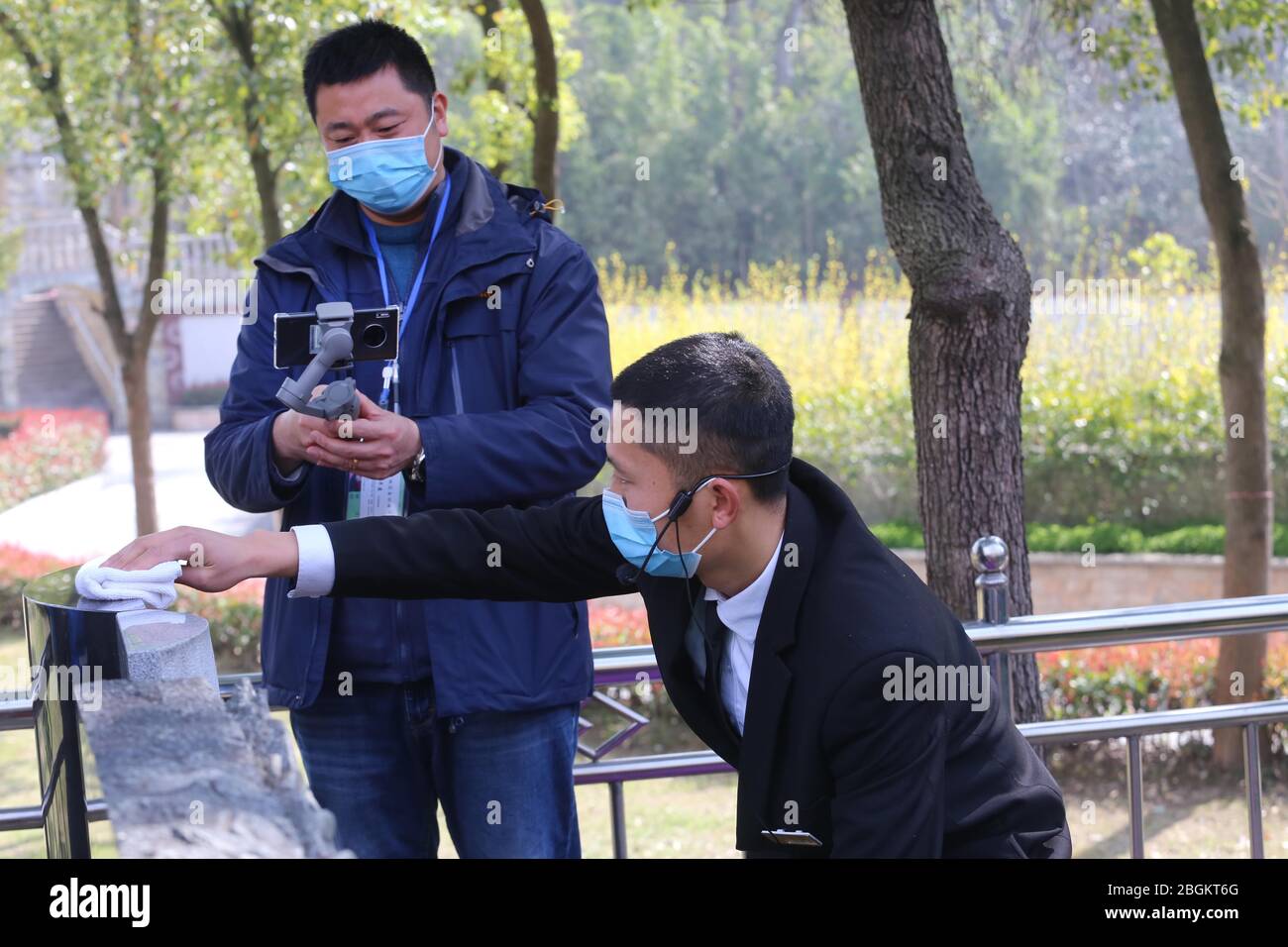 A staff of a local cemetery does online tomb sweeping and worshiping to ...