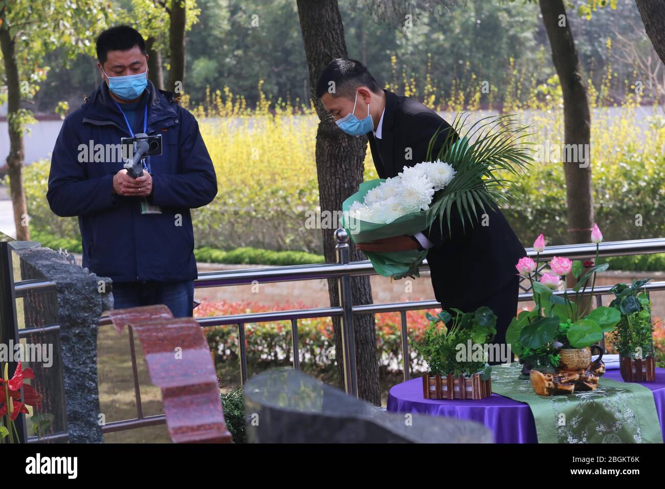 A staff of a local cemetery does online tomb sweeping and worshiping to ...