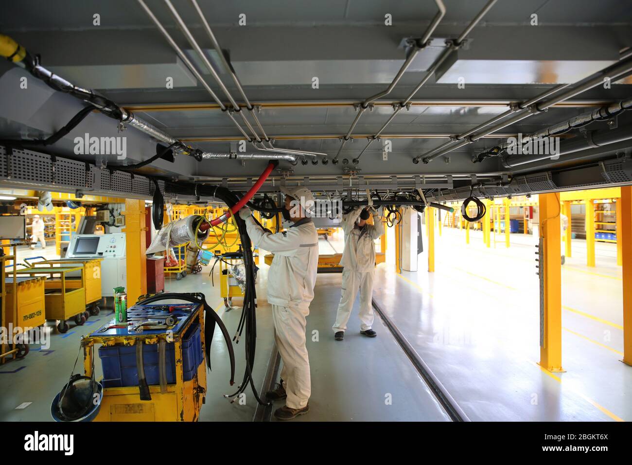 Staff of Chinese rolling stock manufacturer CRRC Qingdao Sifang work to ...