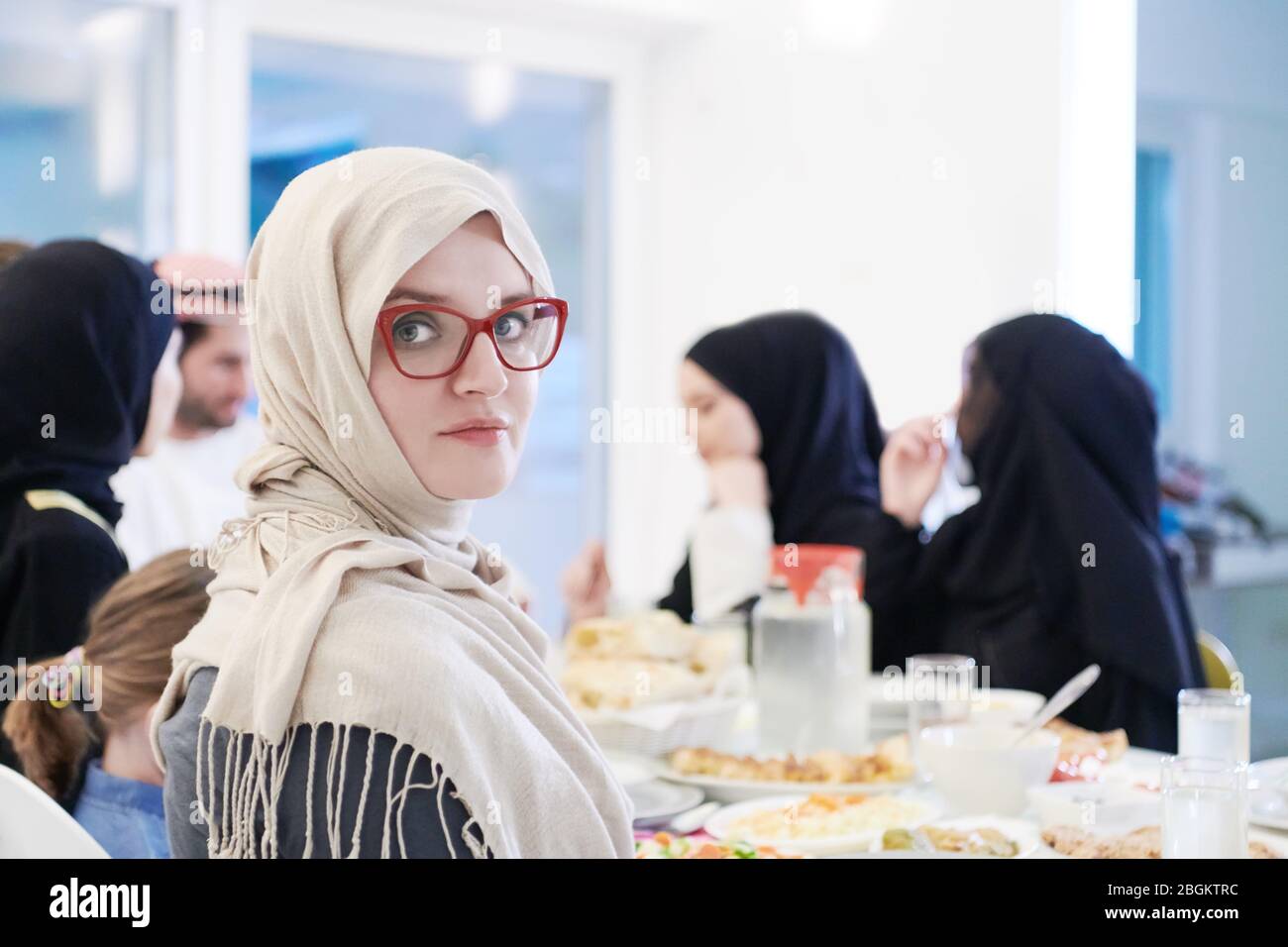 young muslim woman having Iftar dinner with family Eating traditional ...